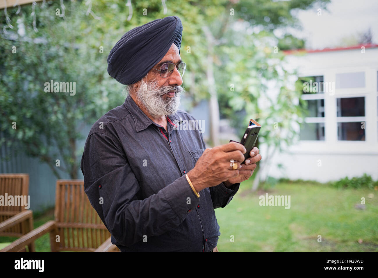 Indian man texting on cell phone Stock Photo - Alamy