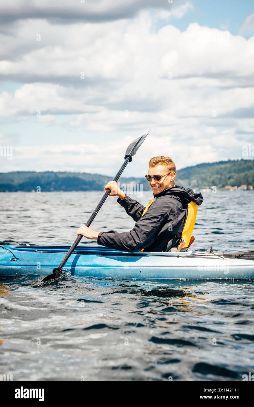 Caucasian man paddling kayak Stock Photo - Alamy