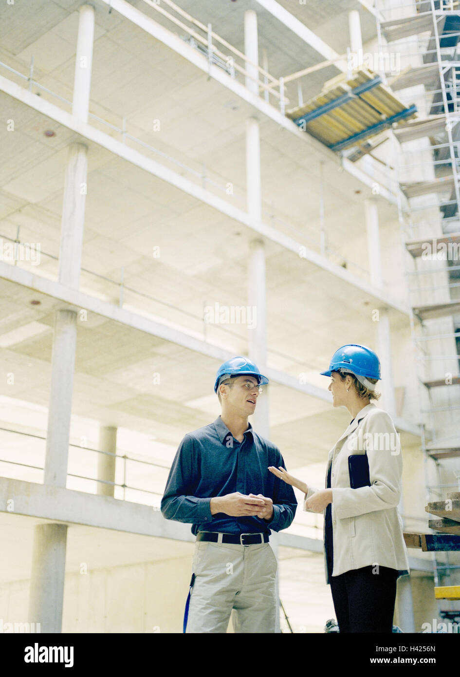 Men at work, architect, woman, man, construction helmets, discussion ...