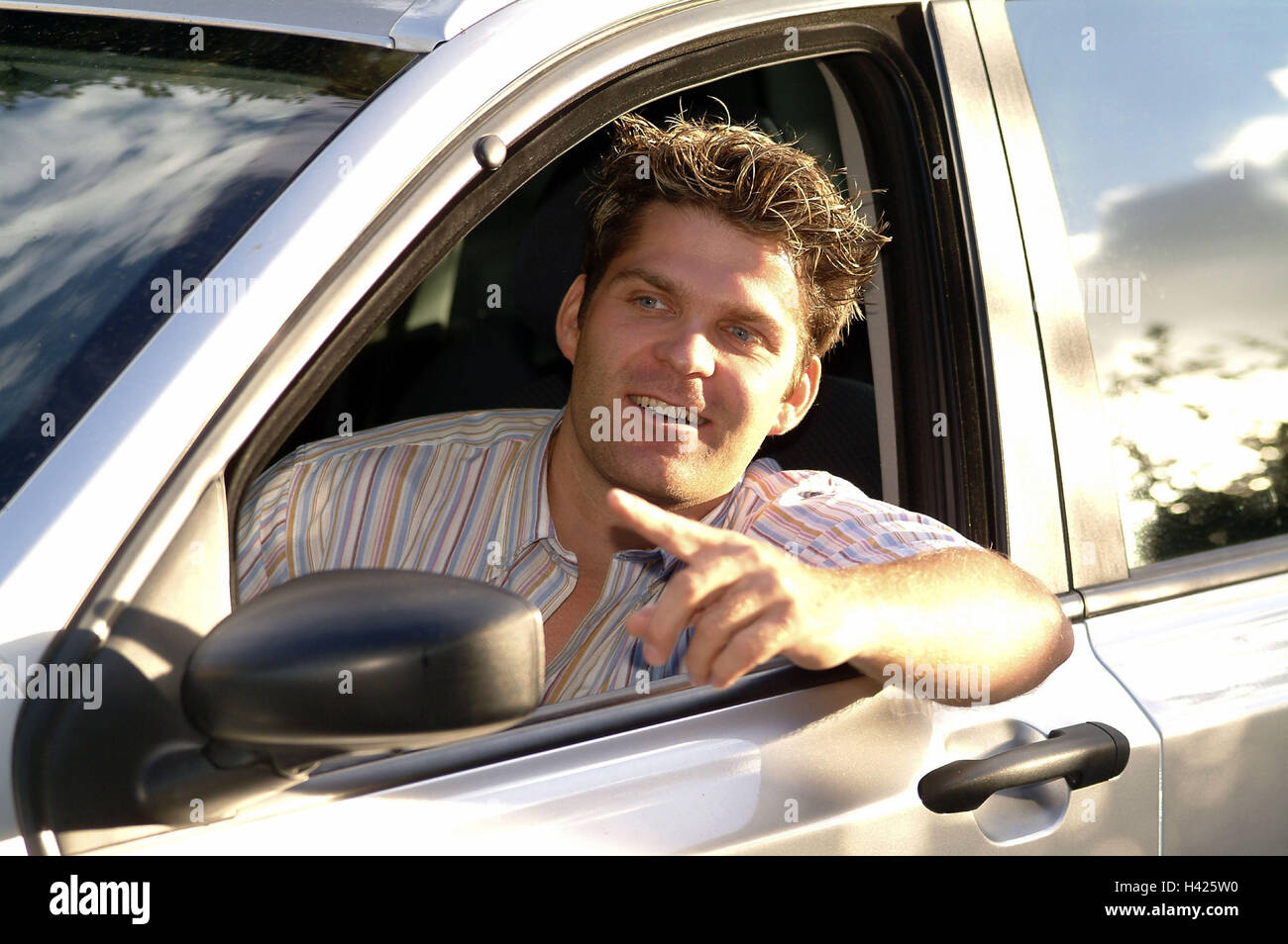 Motorists, gaze side windows, gesture, shows, explains, smiling ...