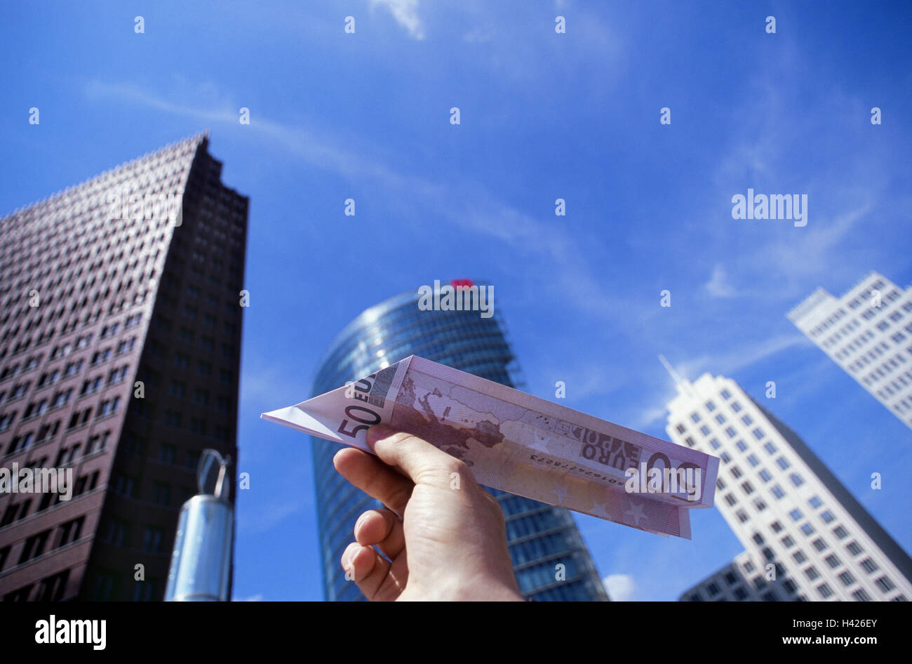 High-rise office blocks, man's hand, paper plane, euro banknote, high ...