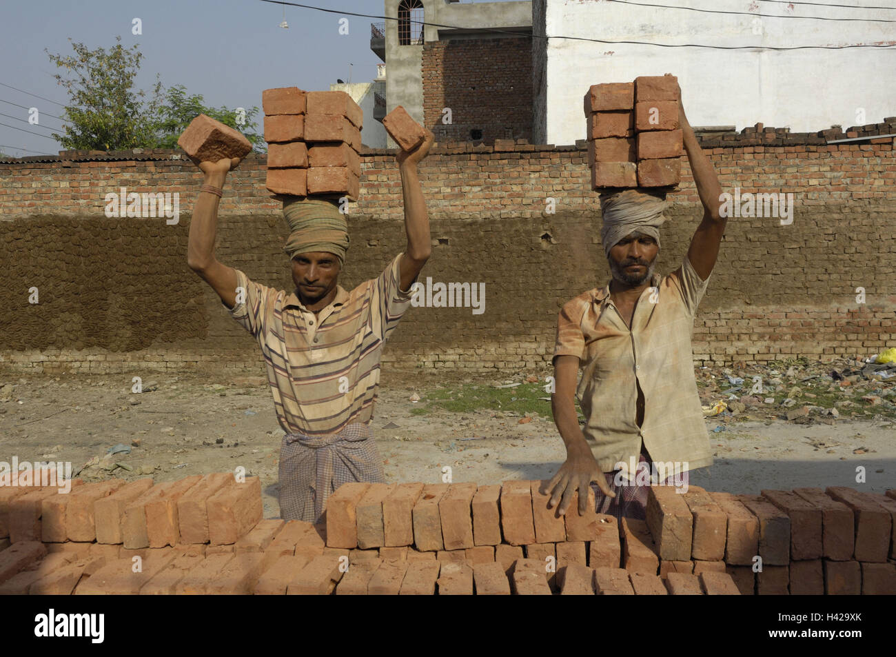 India, Uttar Pradesh, Varanasi, worker, clay brick, carry Stock Photo ...