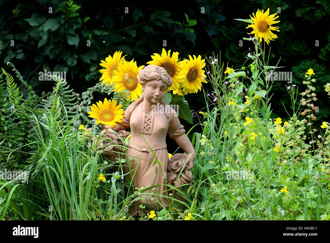 Garden figure with sunflowers Stock Photo - Alamy