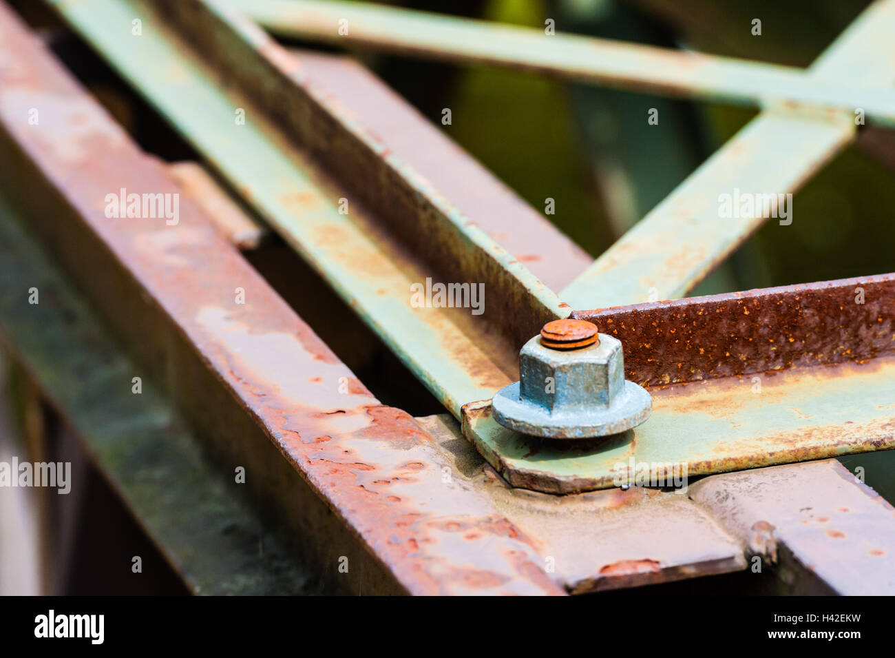 Detail of hexagonal metal screw fastener on corner of partly rusted ...