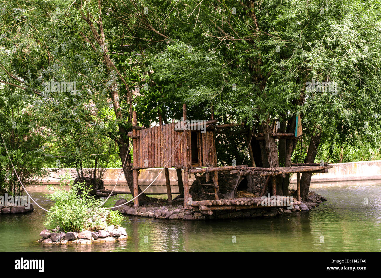 Hut of felled trees on small island at city park Stock Photo - Alamy