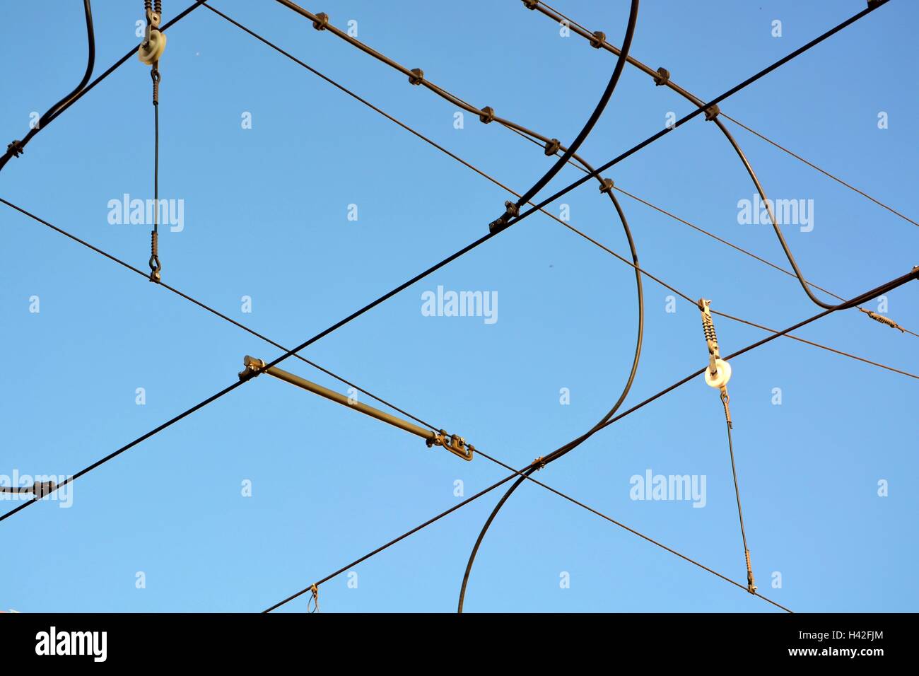 Industrial high voltage power cables against blue sky Stock Photo - Alamy