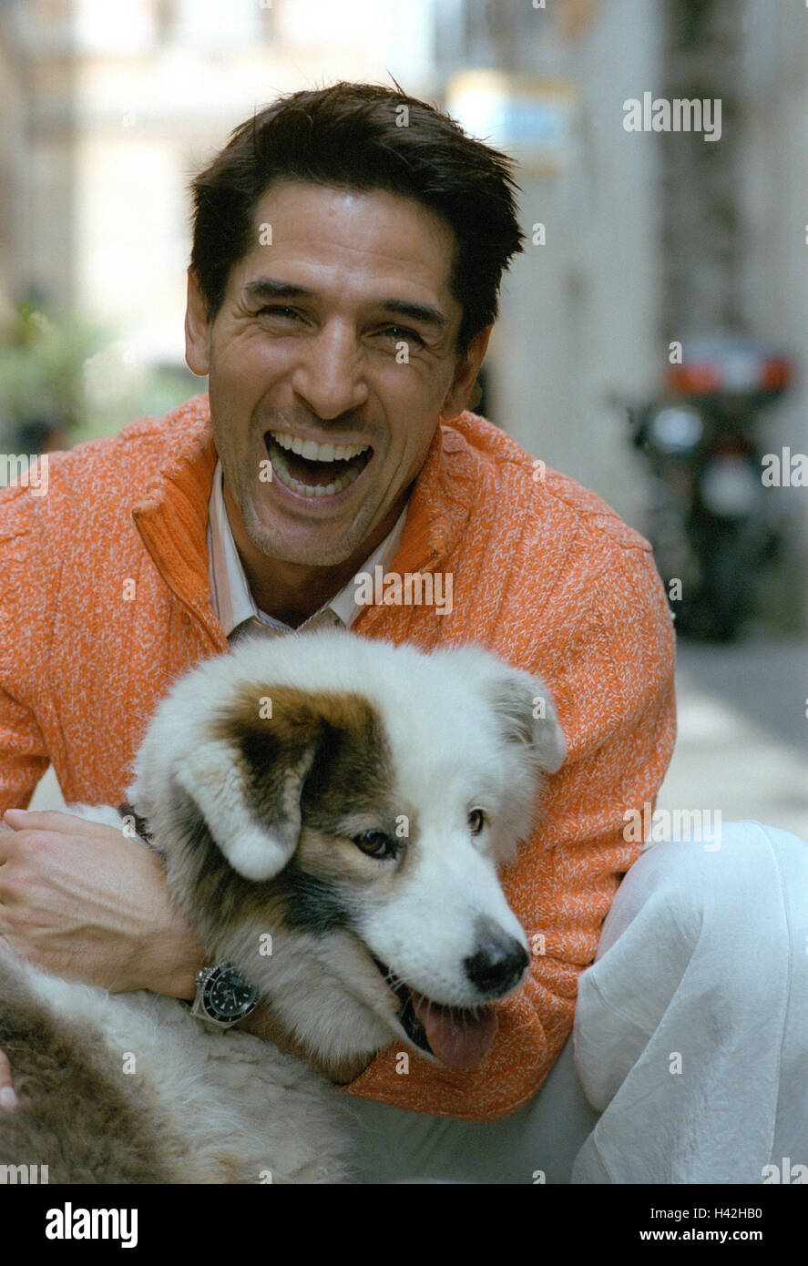 Man, dog, embrace, laugh, detail, 30-40 years, dark-haired, pullover ...