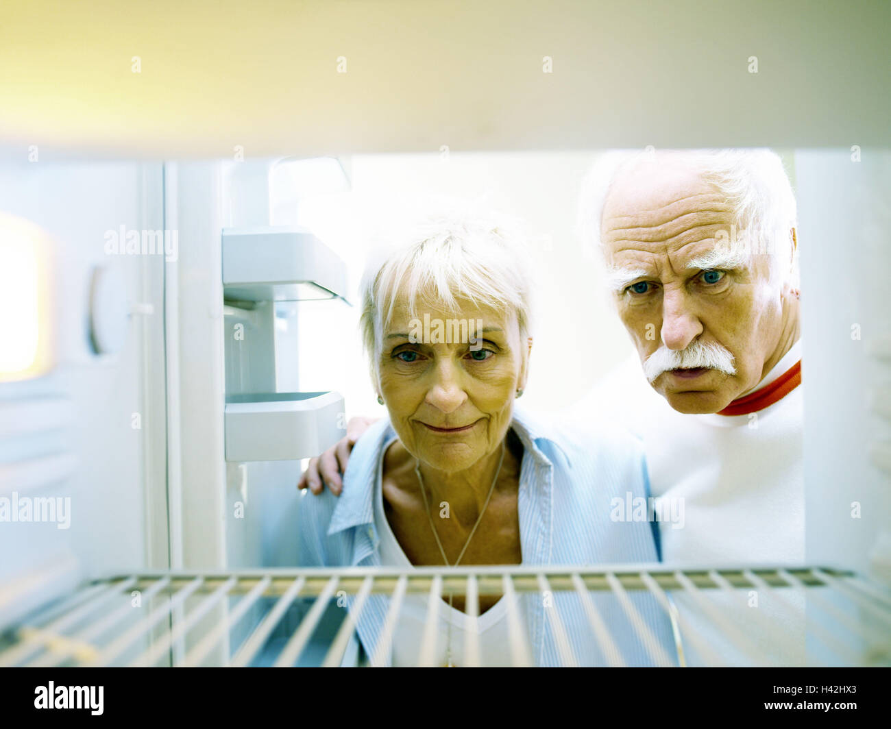 couple of seniors, look, refrigerator, empty, facial expression ...
