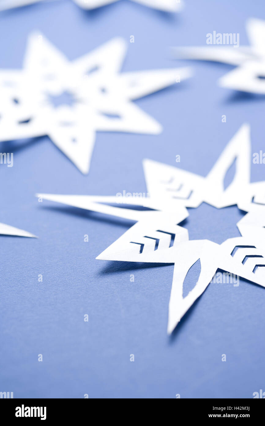 White paper Christmas stars on blue background Stock Photo - Alamy