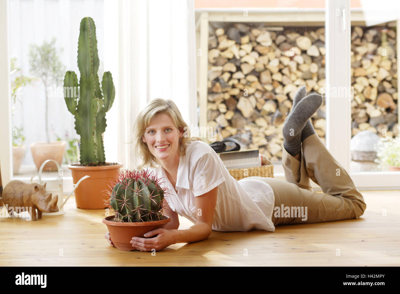 Woman, young, lie, indoor plants, cactus, sphere cactus, Ferocactus ...