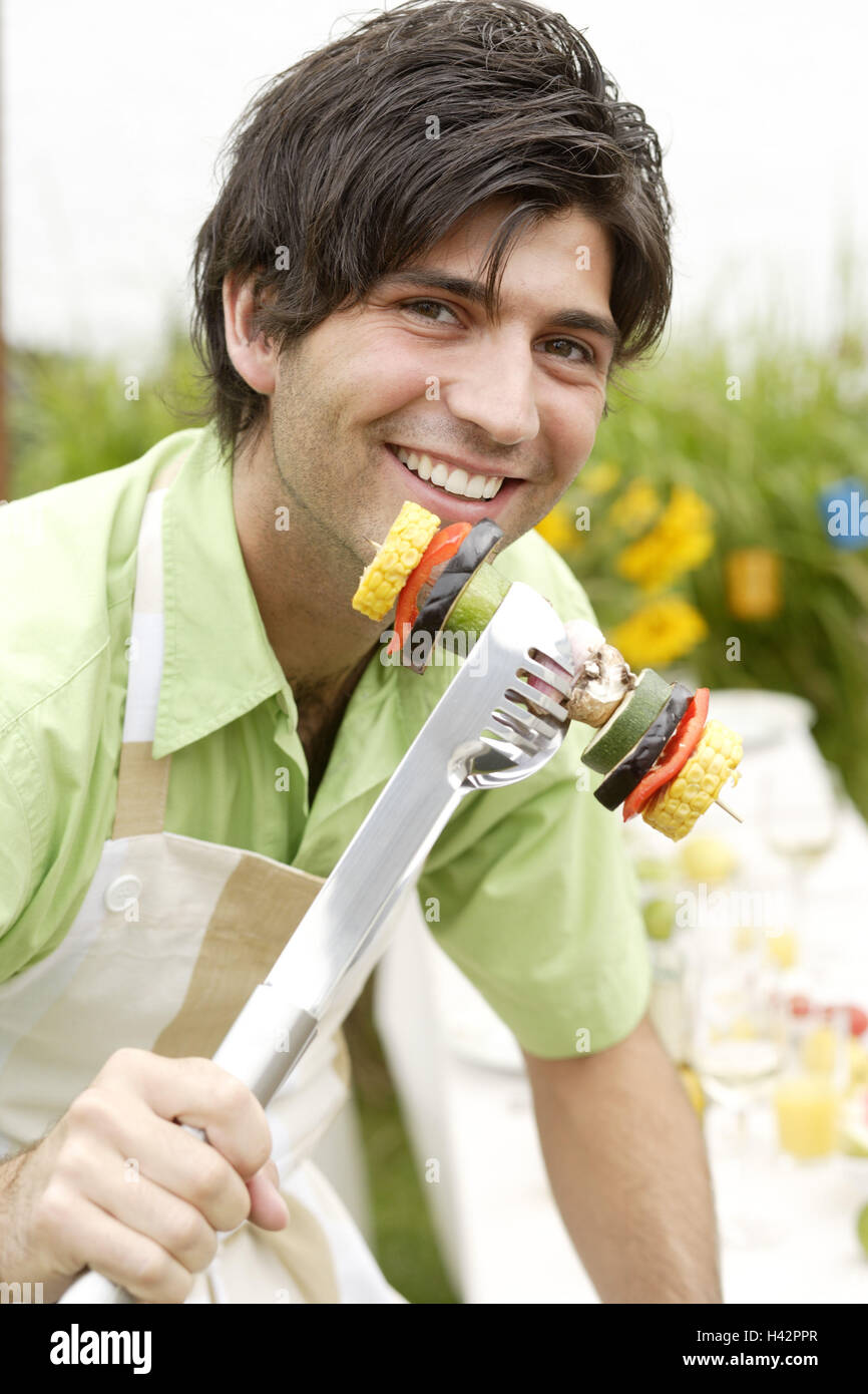 Garden, man, grill liers, smile, hold vegetable spit, portrait Stock ...