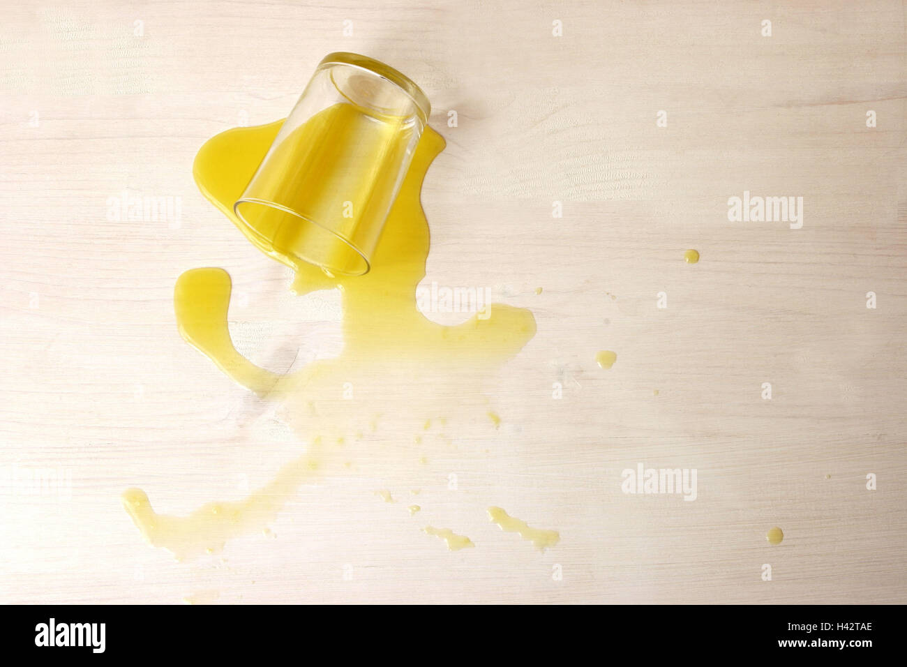 Juice glass, tipped over Stock Photo - Alamy