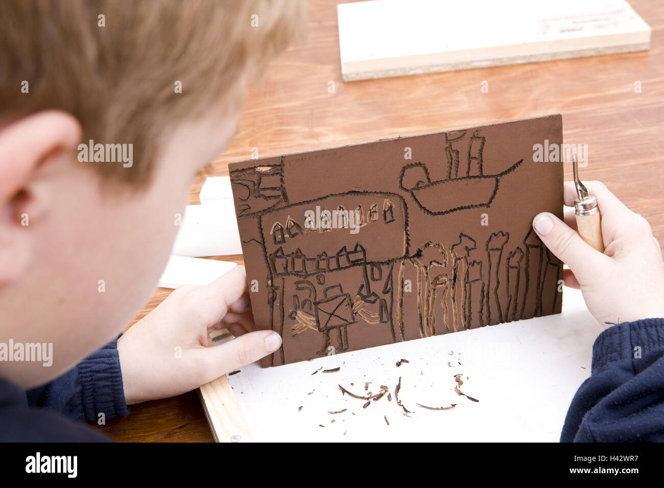 Classroom, art lessons, boy, linocut, looking, back view, cropped Stock ...