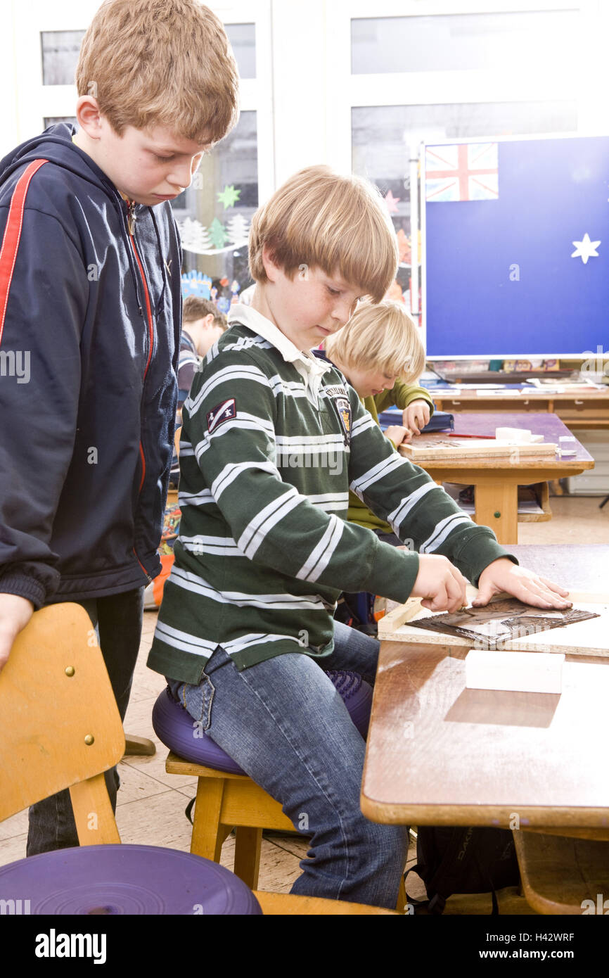 Classroom, art lessons, boy, linocut, concentration Stock Photo - Alamy