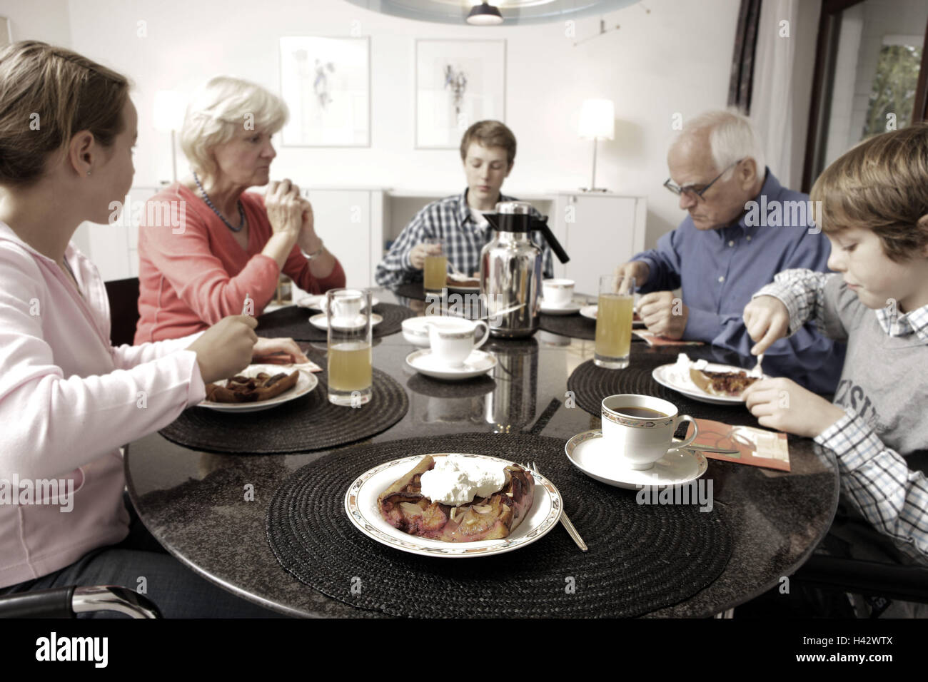 Grandparents, grandchildren, coffee table, together Stock Photo - Alamy