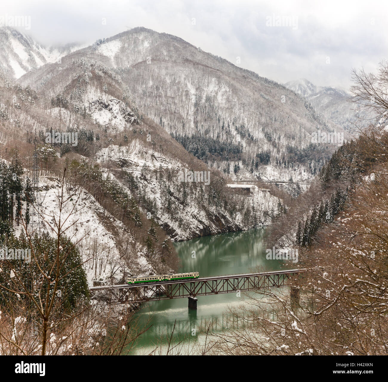 Train in Winter landscape snow on bridge Stock Photo - Alamy