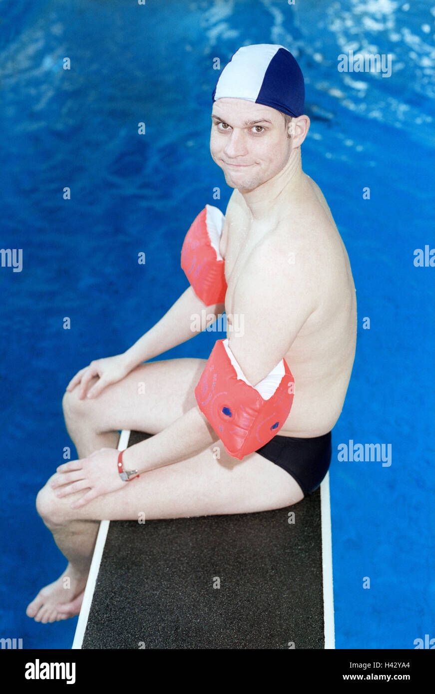 Indoor swimming pool, springboard, man, non-float, shyly, sit, wait ...