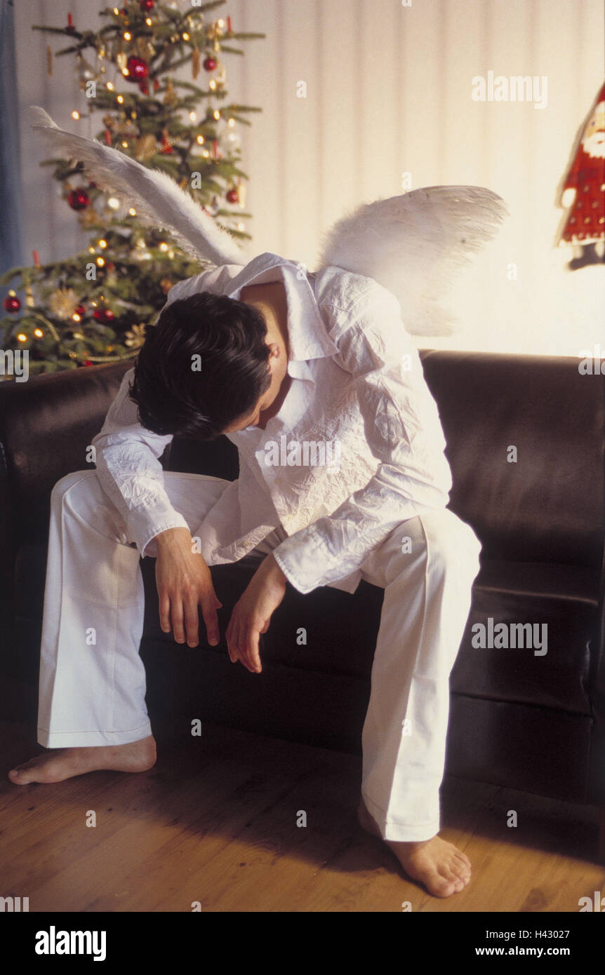 Living space, Christmas tree, sofa, man, angel's wing, disappointment ...