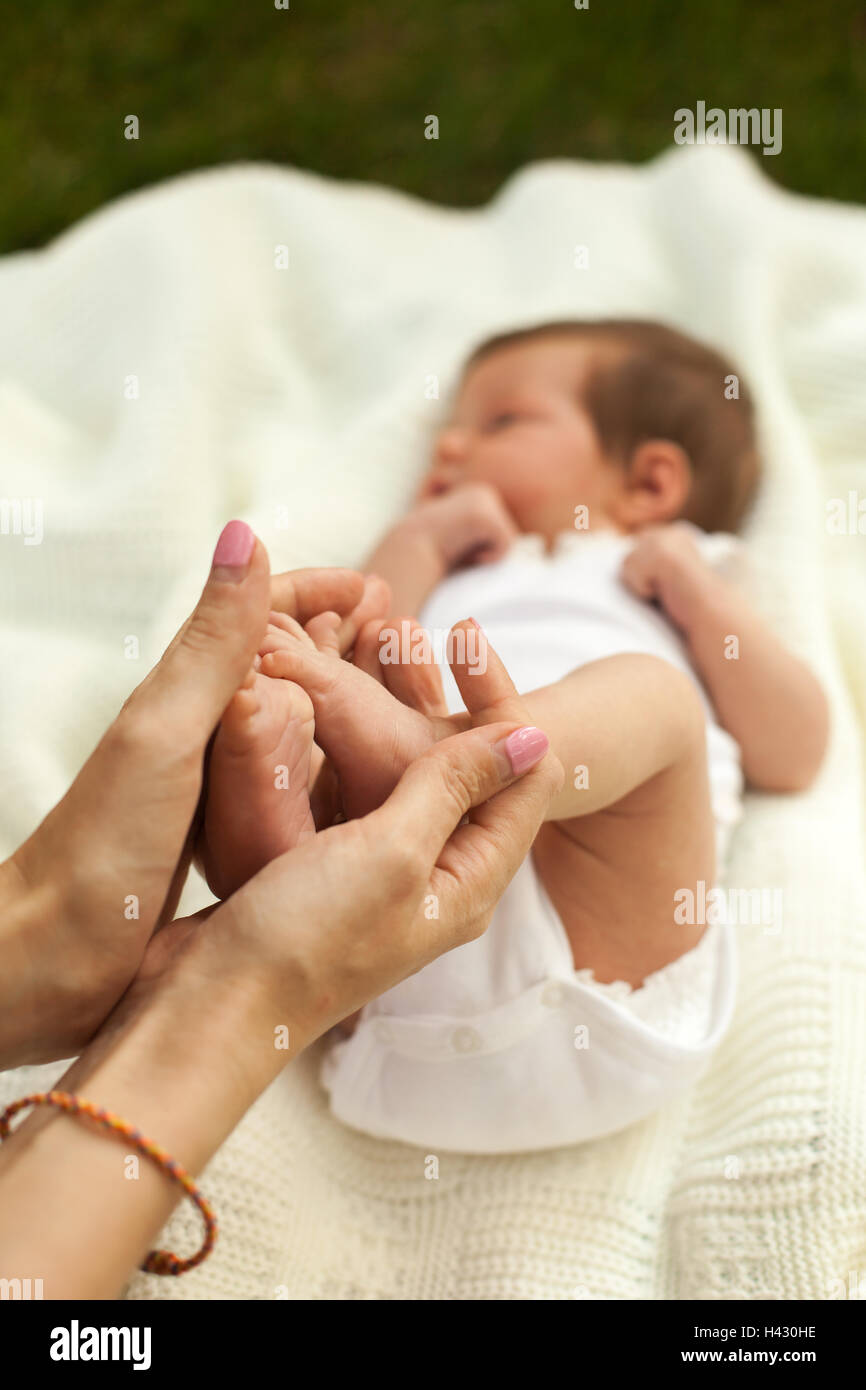 Hand holding little baby's legs Stock Photo - Alamy