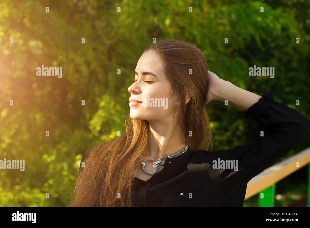 Young woman touching her hair Stock Photo - Alamy