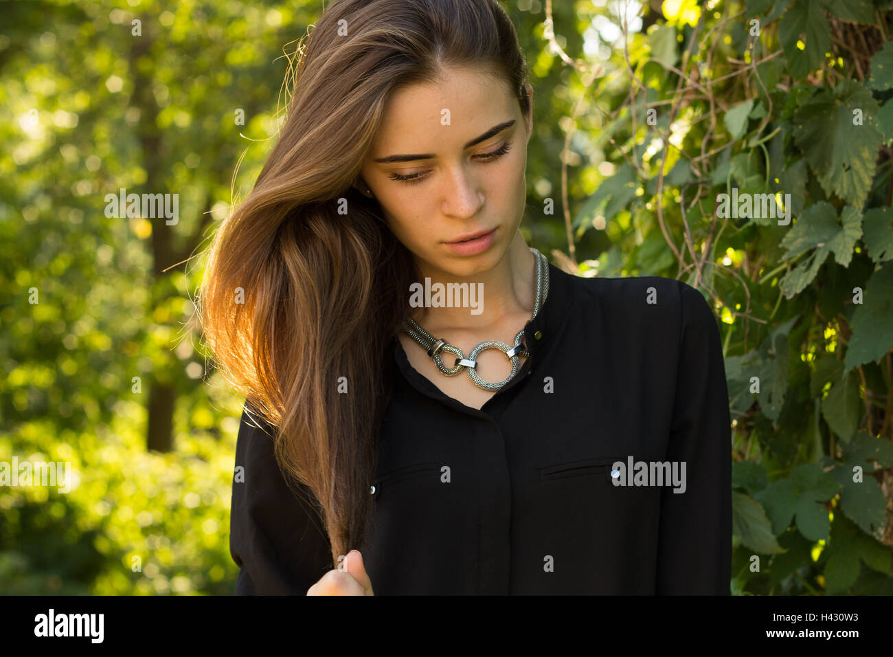 Young touching fixing her hair Stock Photo - Alamy