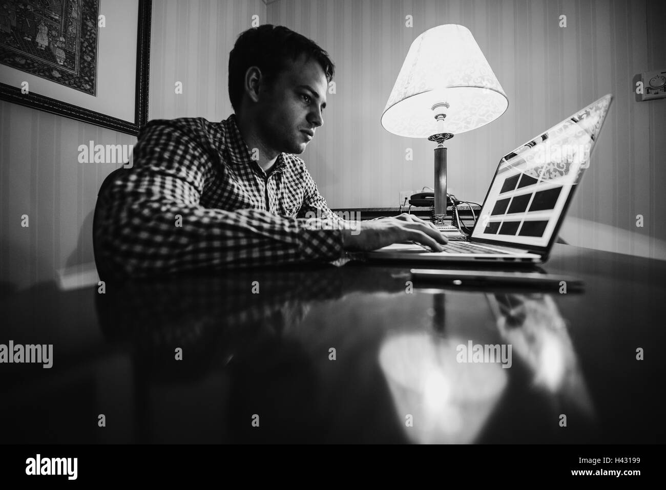 frustrated young business man working on laptop computer at office ...