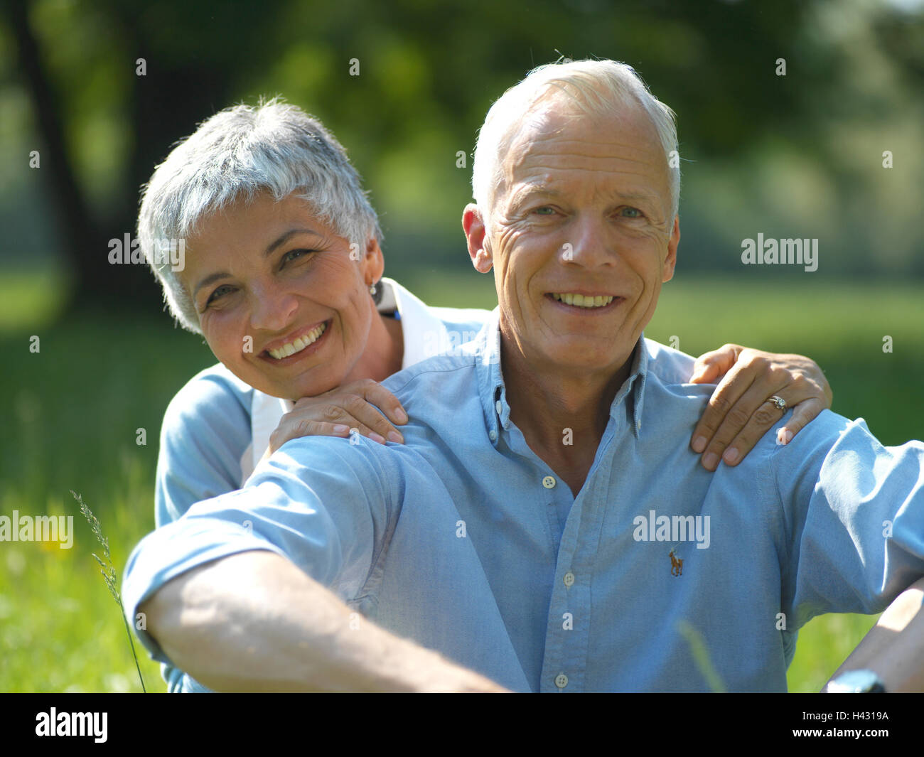 Park, meadow, senior citizen's couple, sit, smile one after the other ...