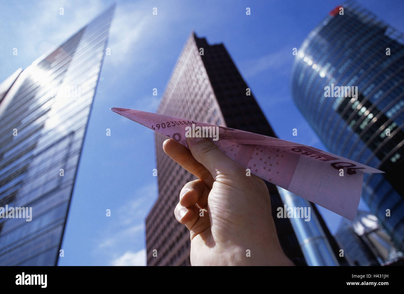 High-rise office blocks, man's hand, paper plane, euro banknote, high ...