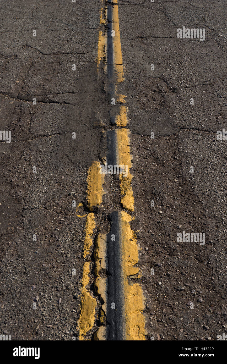 Rugged patched asphalt road with cracks and gaps Stock Photo - Alamy