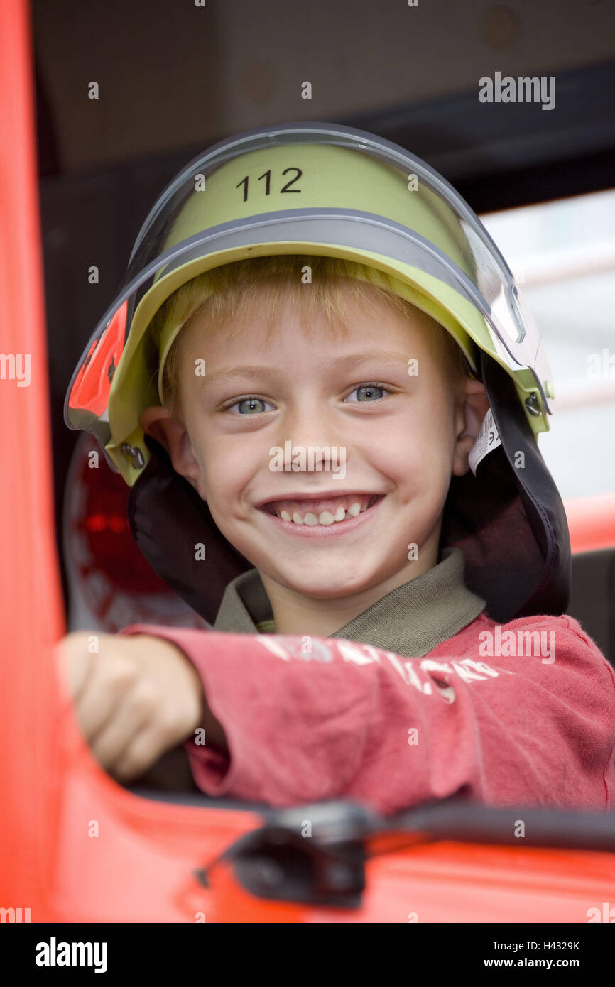 Boy, smile, fire helmet, fire engine, sit, portrait, person, child ...