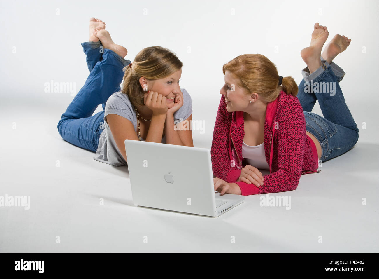 Young persons, girls, lie, smile, laptop, data entry, model released ...