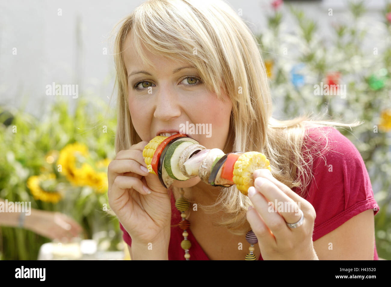 Woman, vegetable spit, bite, portrait, garden Stock Photo - Alamy
