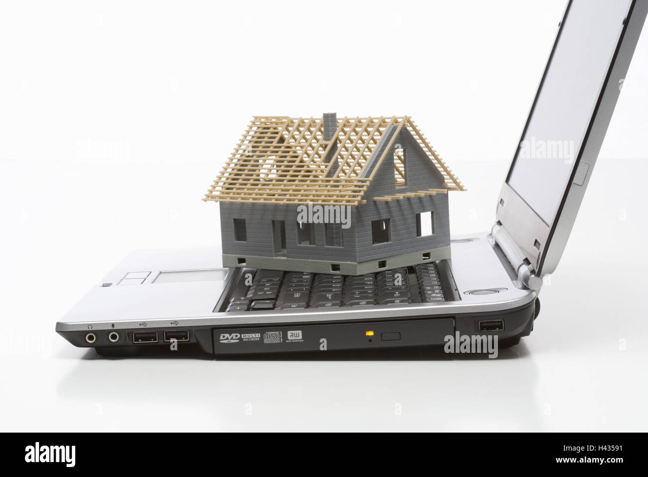 Laptop, house model Stock Photo - Alamy