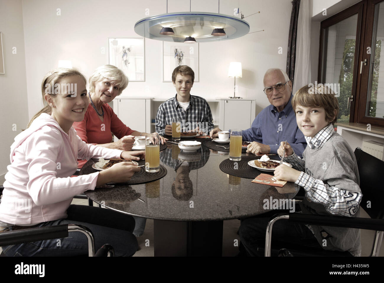 Grandparents, grandchildren, coffee table, together Stock Photo - Alamy