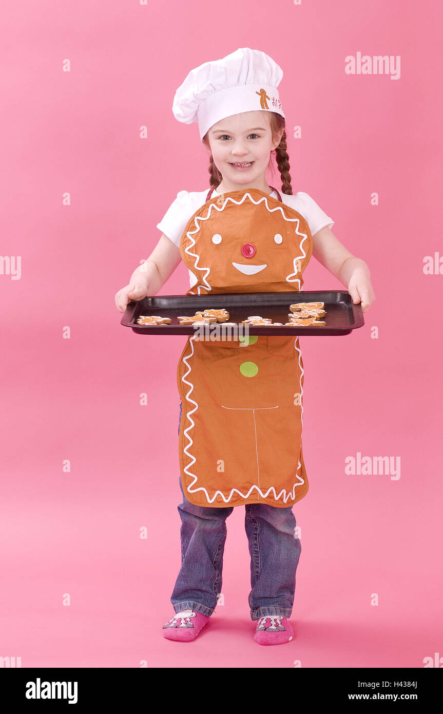 Girls, baking sheet, biscuit, studio, stand Stock Photo - Alamy