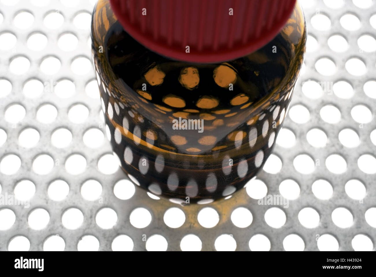Amber Bottle, screw cap, perforated plate, detail Stock Photo - Alamy