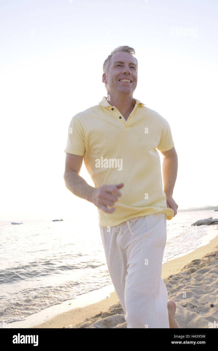 Man, middle old person, beach, jog, model released Stock Photo - Alamy
