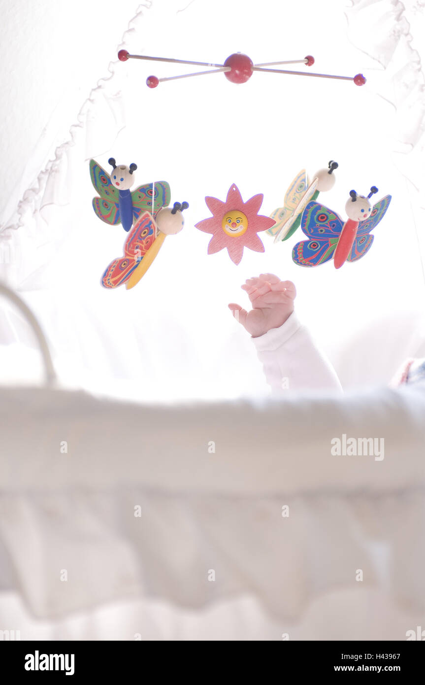 Baby, lying, hand reaching for mobile, detail Stock Photo - Alamy