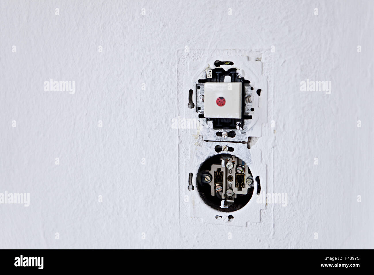 Wall, light switch and socket without cover Stock Photo - Alamy
