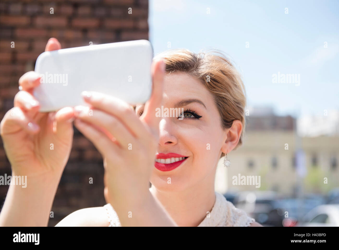 Caucasian woman posing for cell phone selfie Stock Photo - Alamy