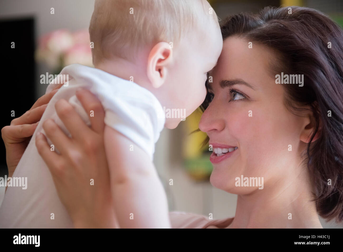 Caucasian mother touching foreheads with baby son Stock Photo - Alamy