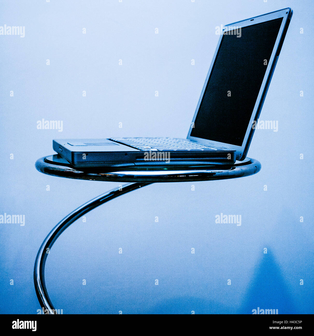 Laptop on round table Stock Photo - Alamy