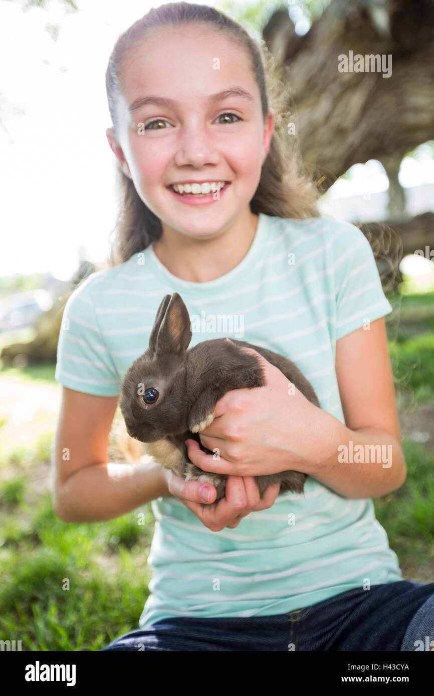 Caucasian girl holding rabbit Stock Photo - Alamy