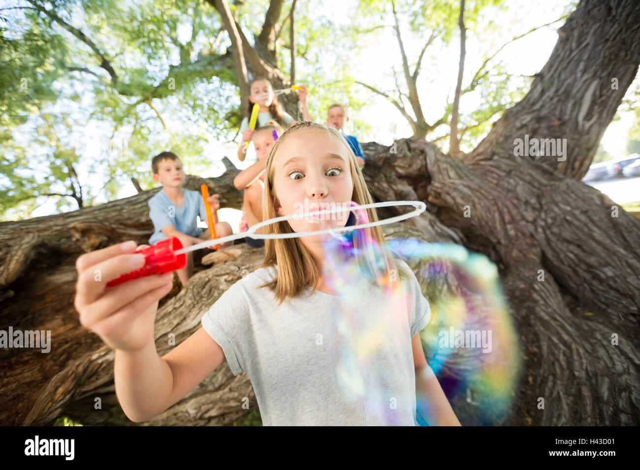 Caucasian girl making bubbles Stock Photo - Alamy