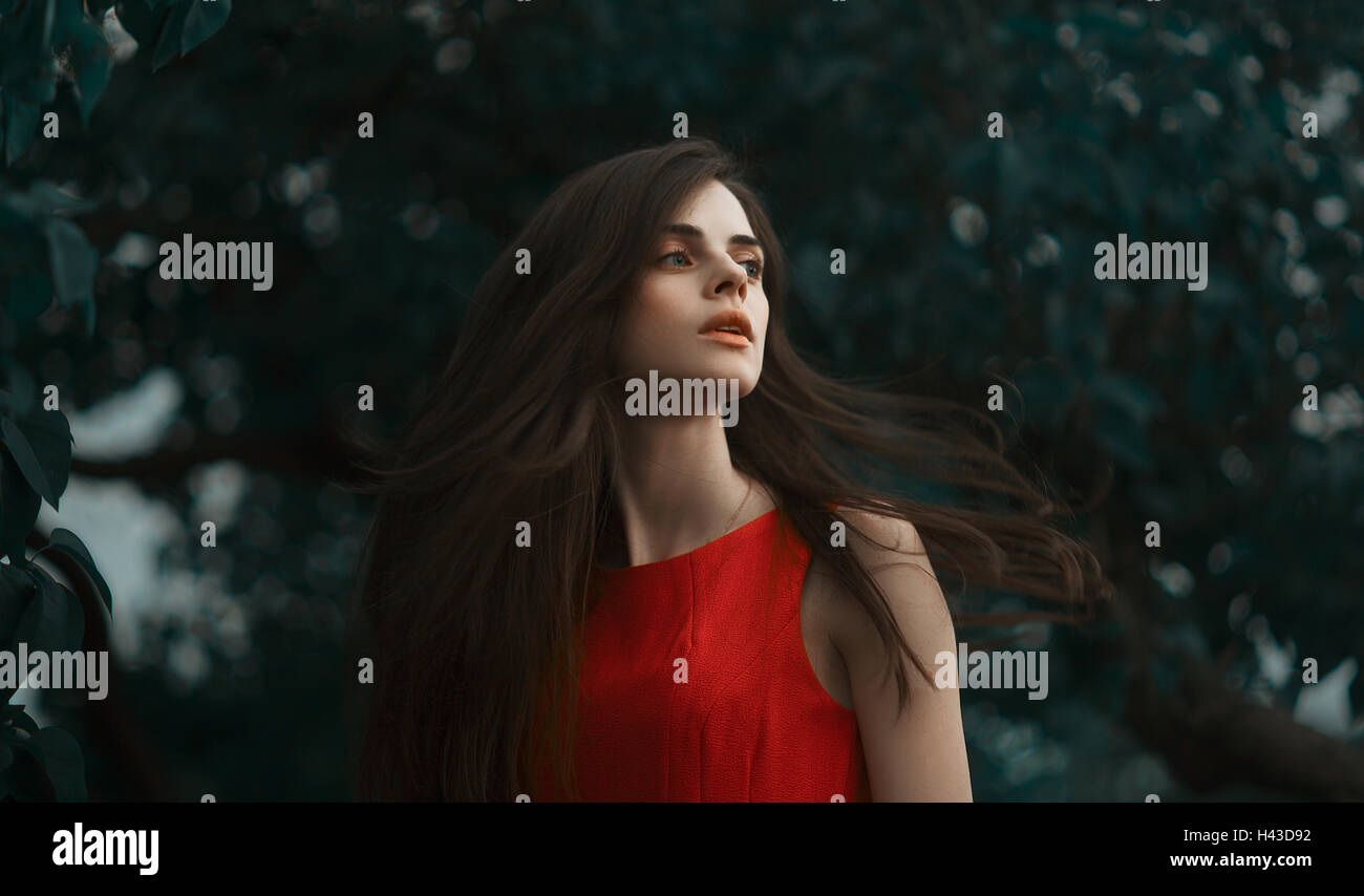 Caucasian woman spinning hair Stock Photo - Alamy
