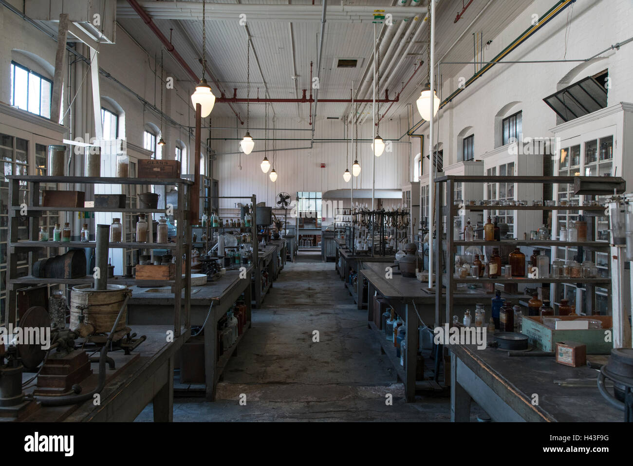 Tables and jars in empty old-fashioned factory Stock Photo - Alamy