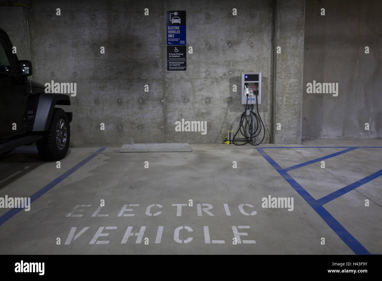 Electric vehicle parking space and charging station Stock Photo - Alamy