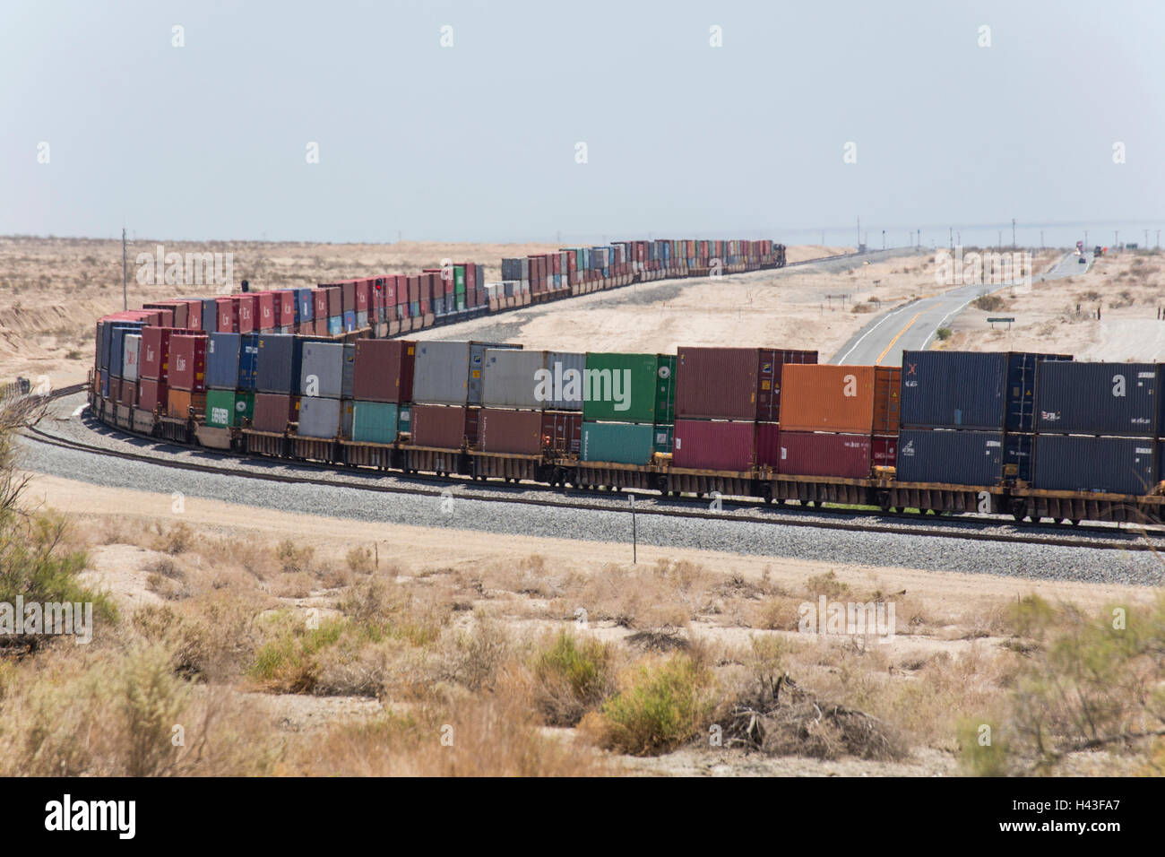 Cargo containers on curving railroad track Stock Photo - Alamy