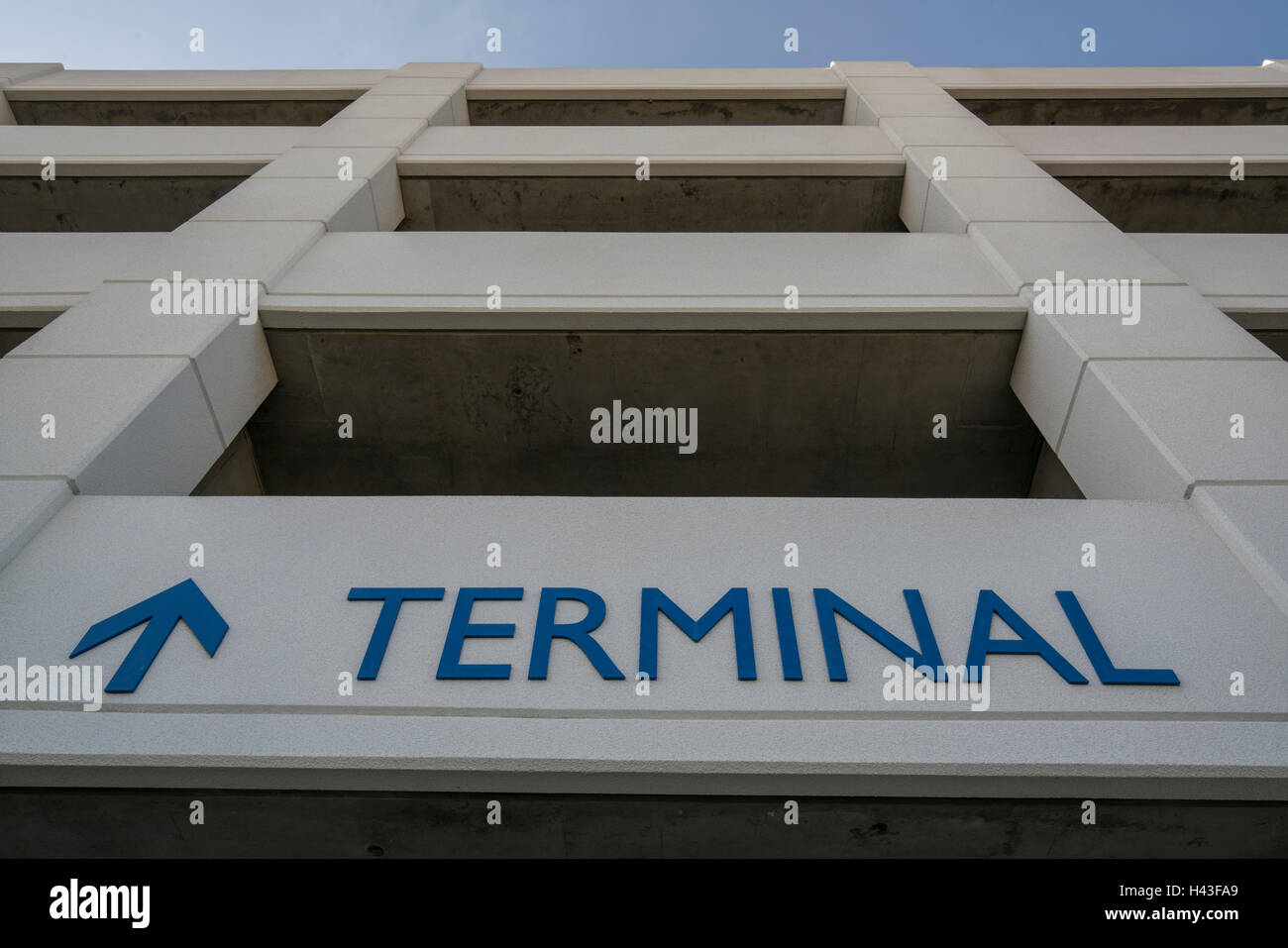 Arrow and terminal sign on parking garage Stock Photo - Alamy