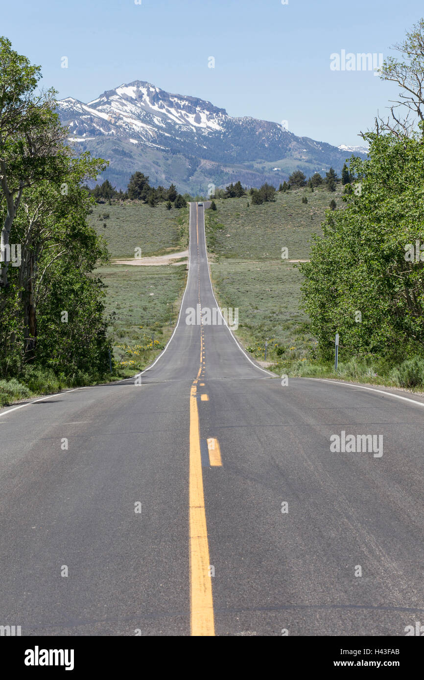 Distant car on freeway near mountain Stock Photo - Alamy